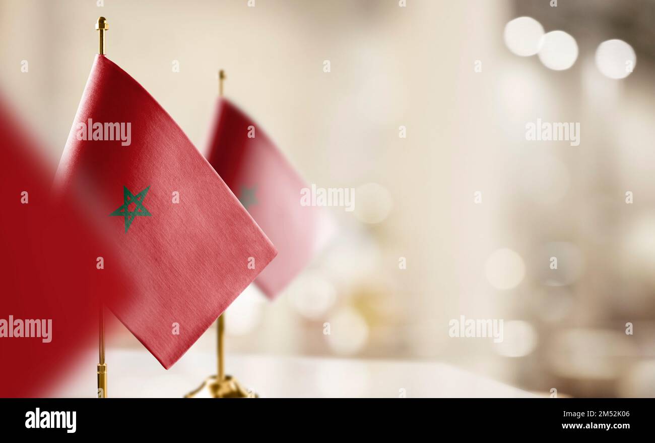 Small flags of the Morocco on an abstract blurry background Stock Photo ...
