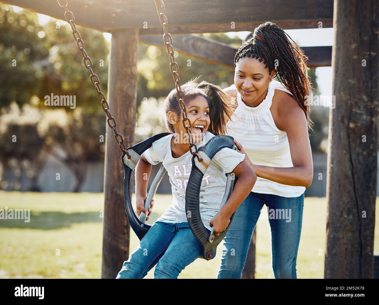 Mother pushing daughter swing hi-res stock photography and images - Alamy