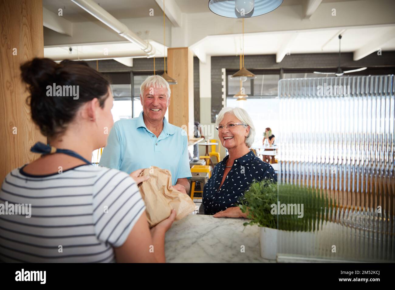 Were picking up our usual order. a senior couple being served by a ...