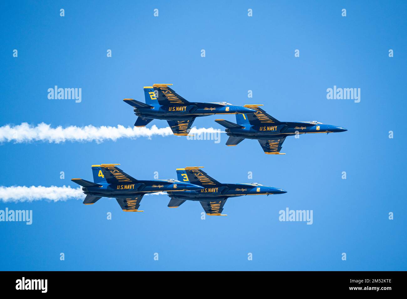 An air show with Blue Angels flying over the town Stock Photo - Alamy
