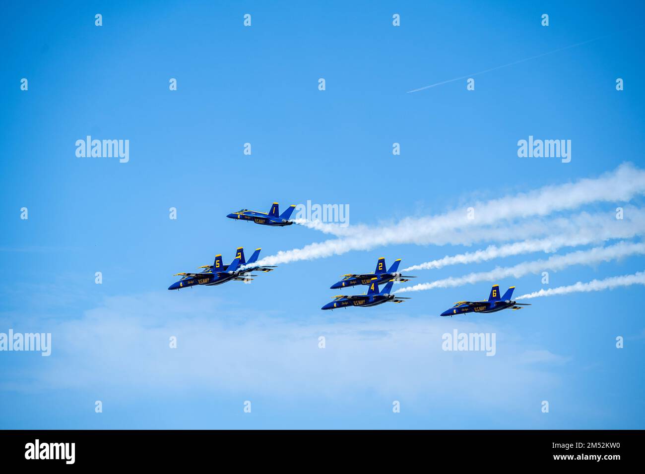 An air show with Blue Angels flying over the town Stock Photo - Alamy
