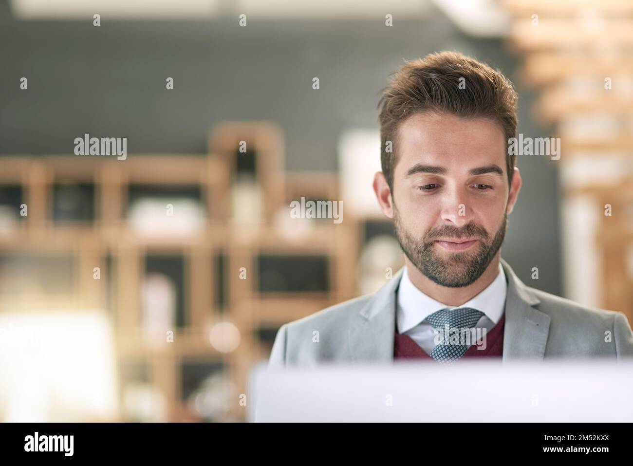 Facing his work tasks with focus. a businessman using a laptop at his ...