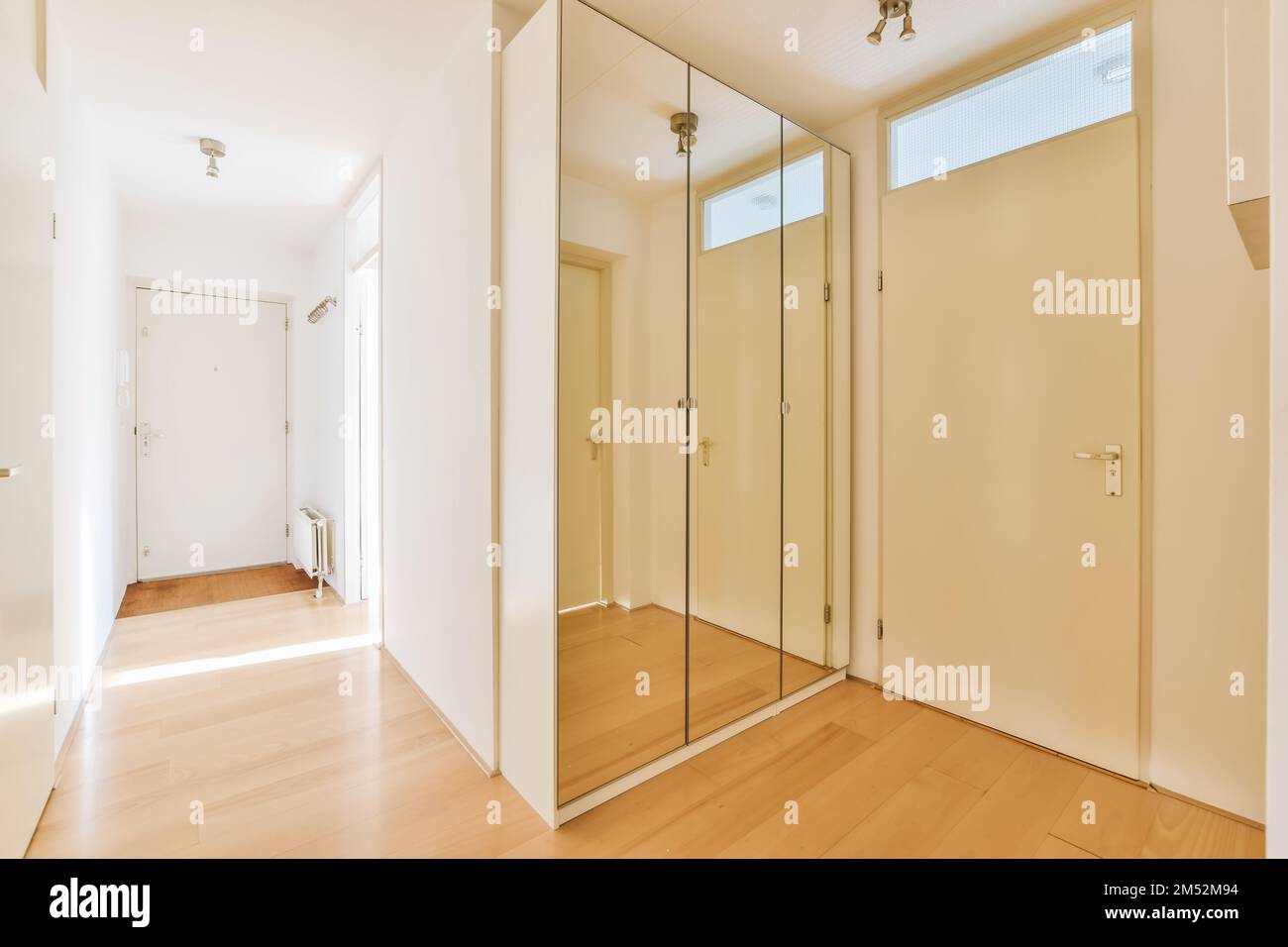 an empty room with wood flooring and glass partitions on the walls ...