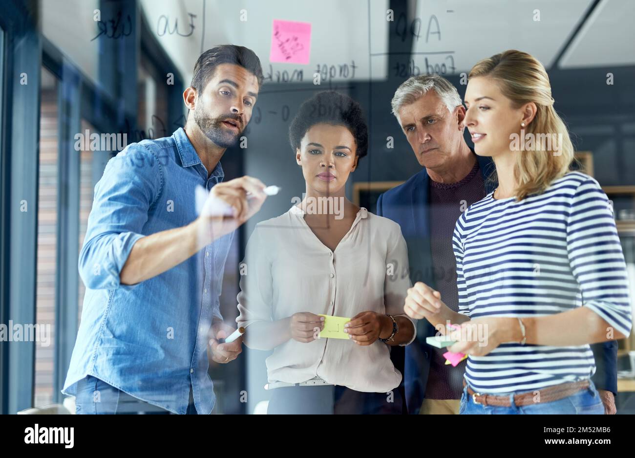 Approaching a brainstorming task as a team. a group of colleagues having a brainstorming session ...