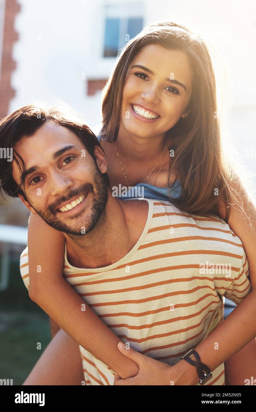 This is by far my favorite love story. Portrait of a happy young man giving his girlfriend a ...