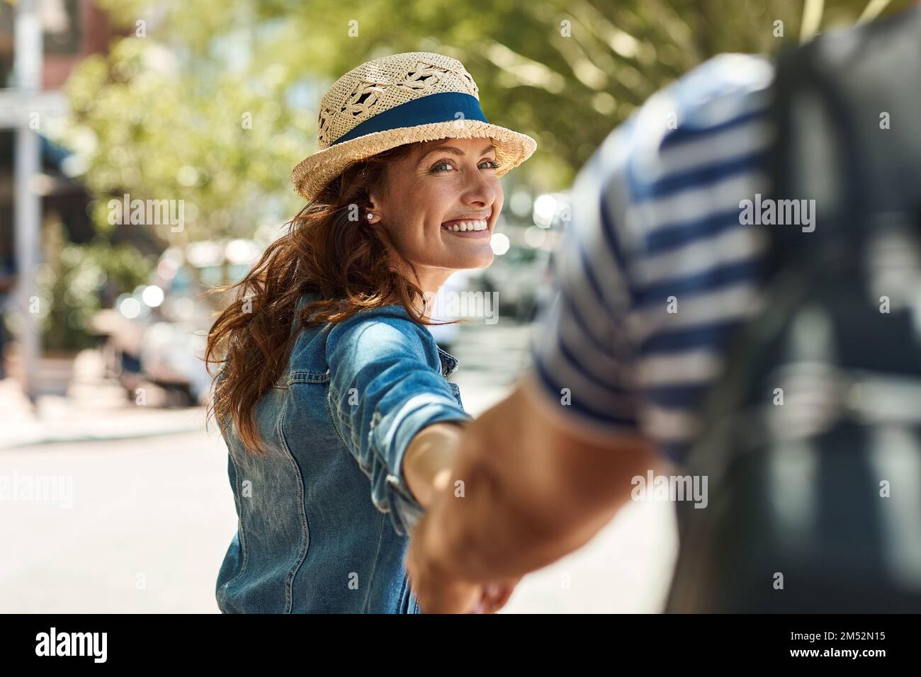 Lets go see whats around that corner. a happy tourist leading her ...