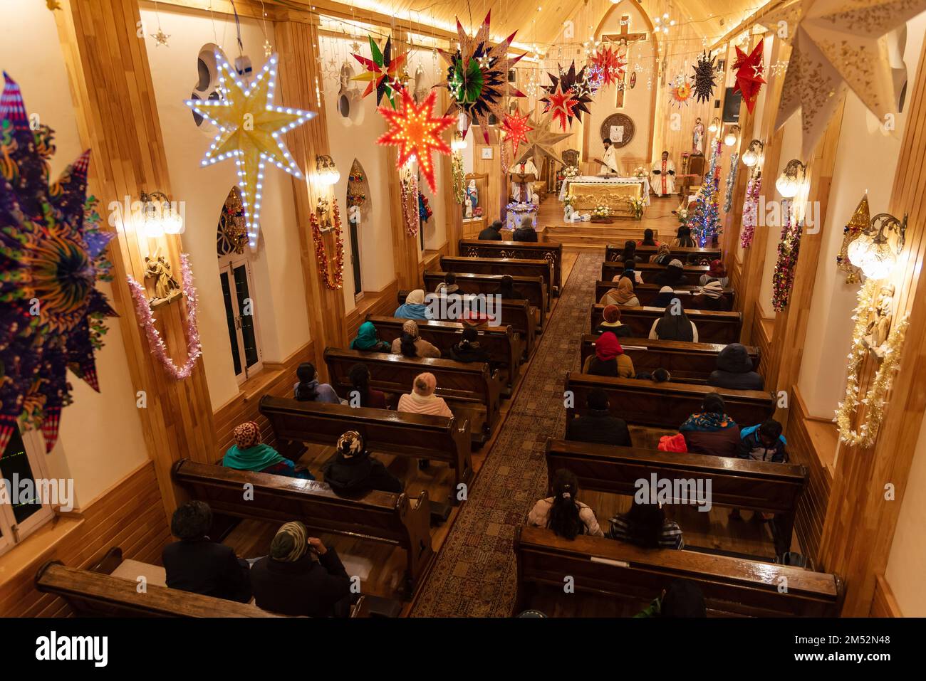 Srinagar, India. 24th Dec, 2022. People offer prayers inside a catholic ...