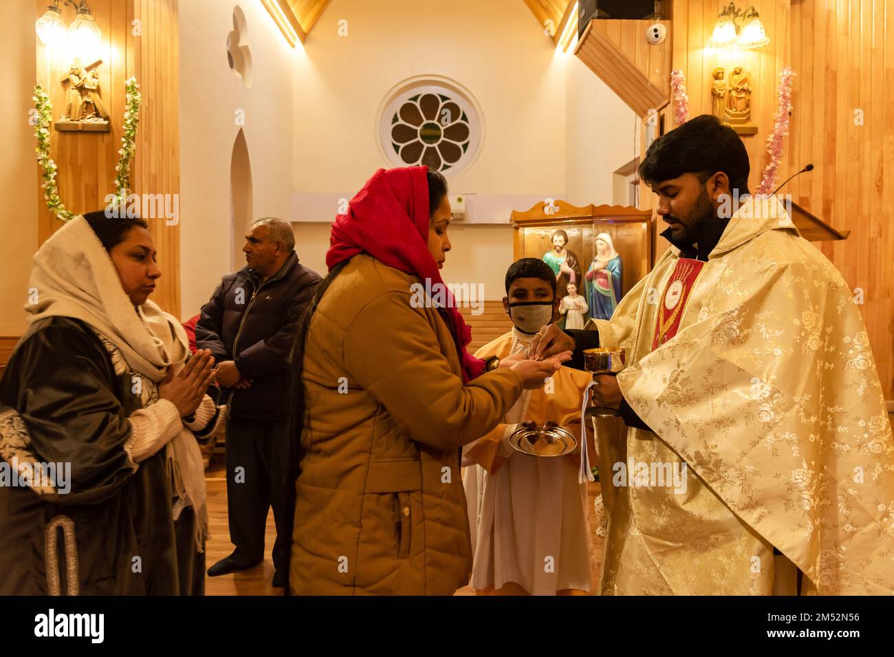 Srinagar, India. 24th Dec, 2022. Catholic priest is seen giving holy ...