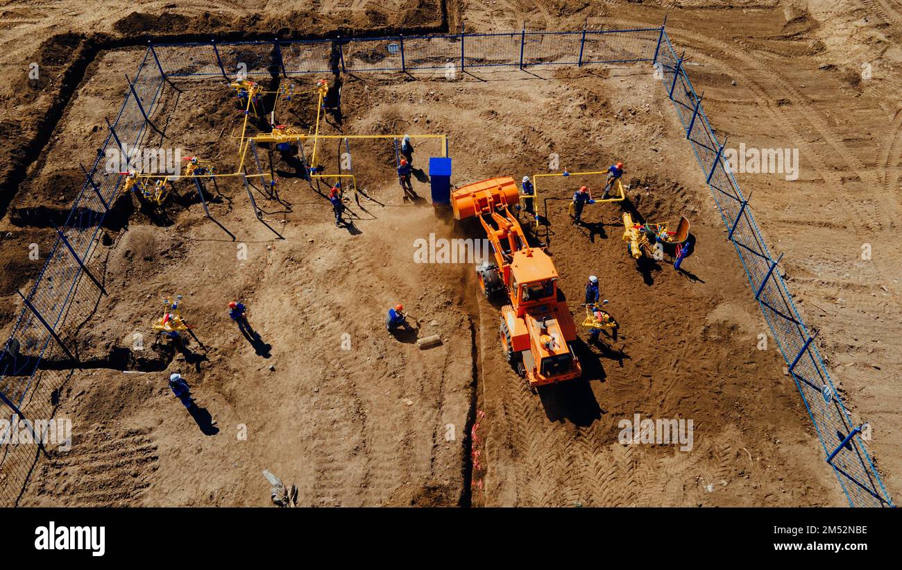 Aerial view excavator and construction workers working on construction ...