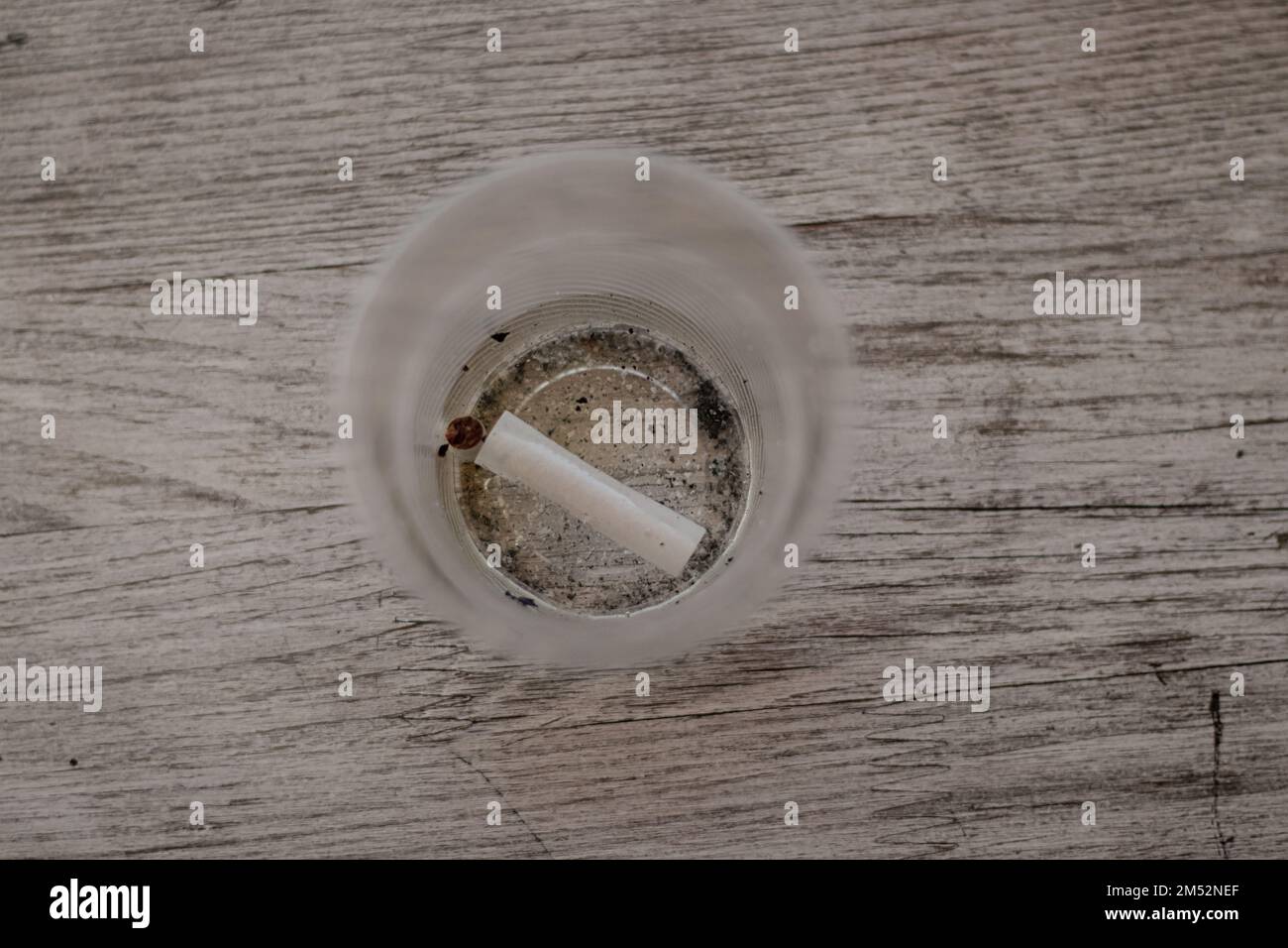filter from a cigarette smoked floats in a plastic glass Stock Photo ...