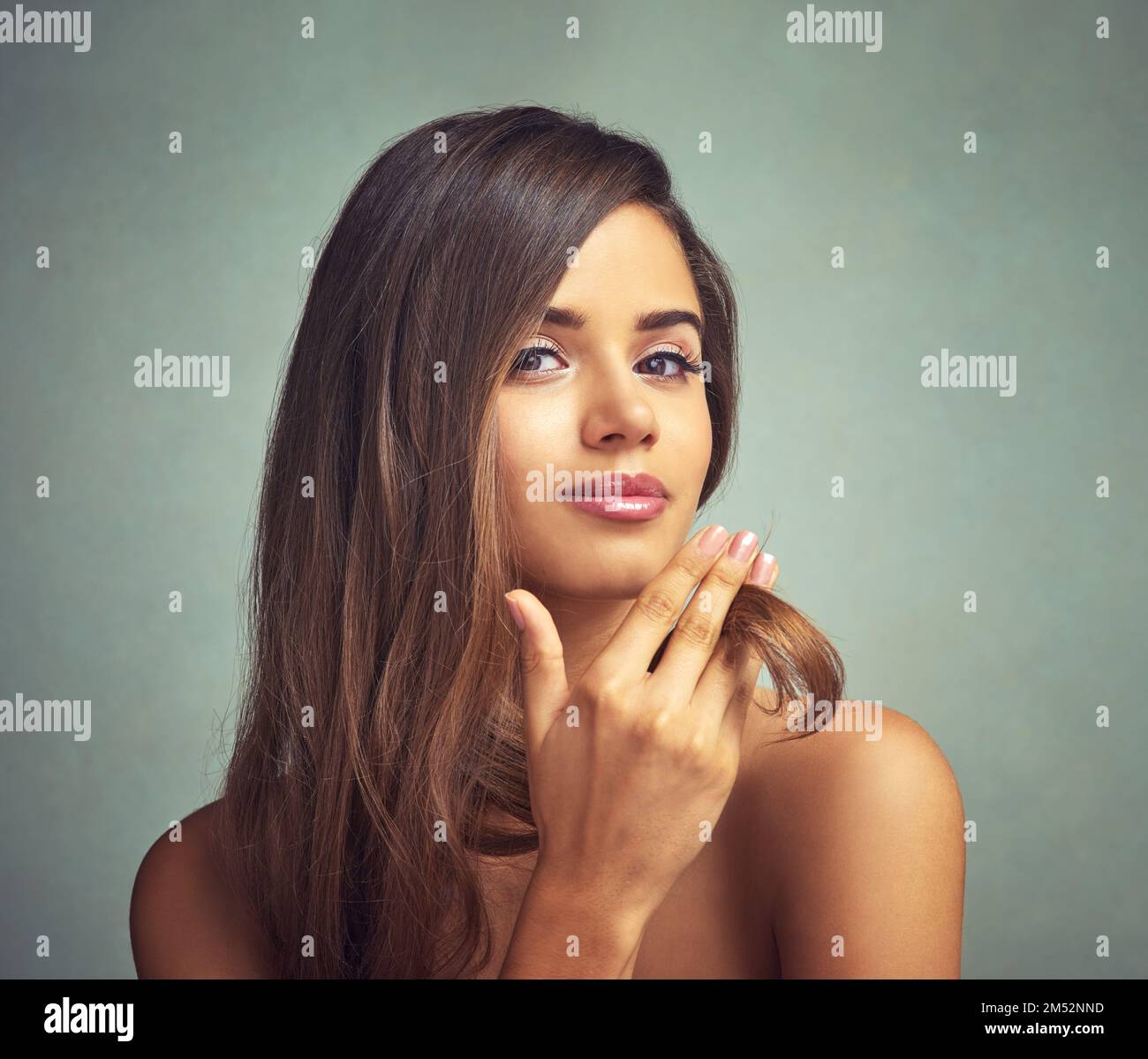 Less makeup, more me. Studio portrait of a beautiful woman with long ...