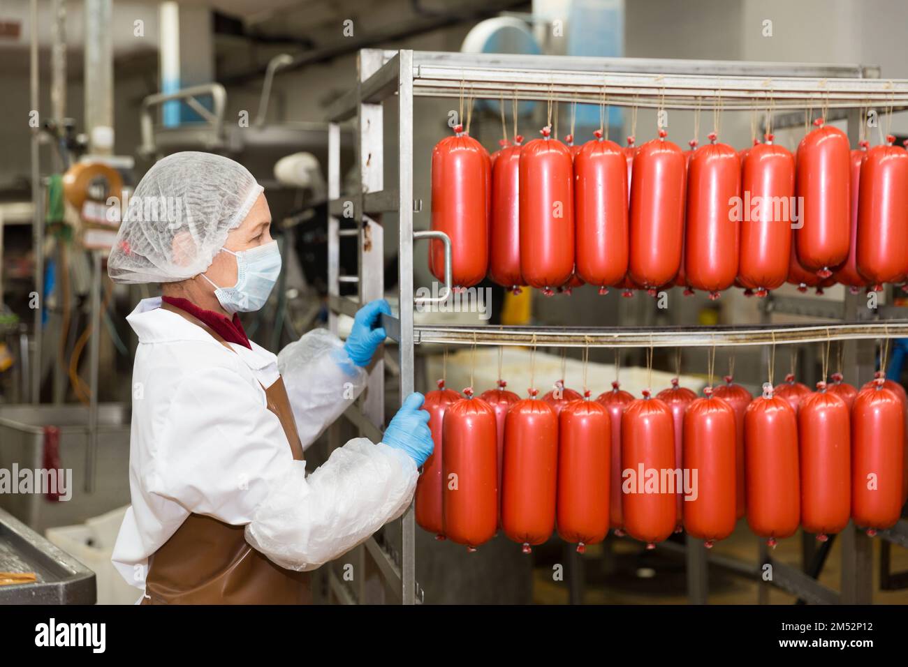 Woman with sausage trolley Stock Photo - Alamy