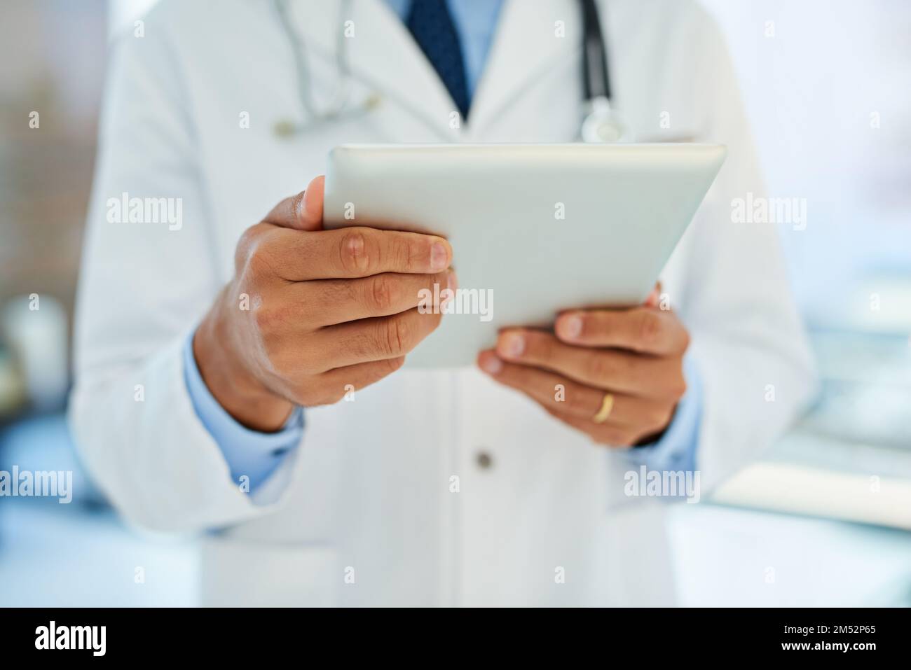 Patient files are so old-fashioned. an unidentifiable doctor checking a ...
