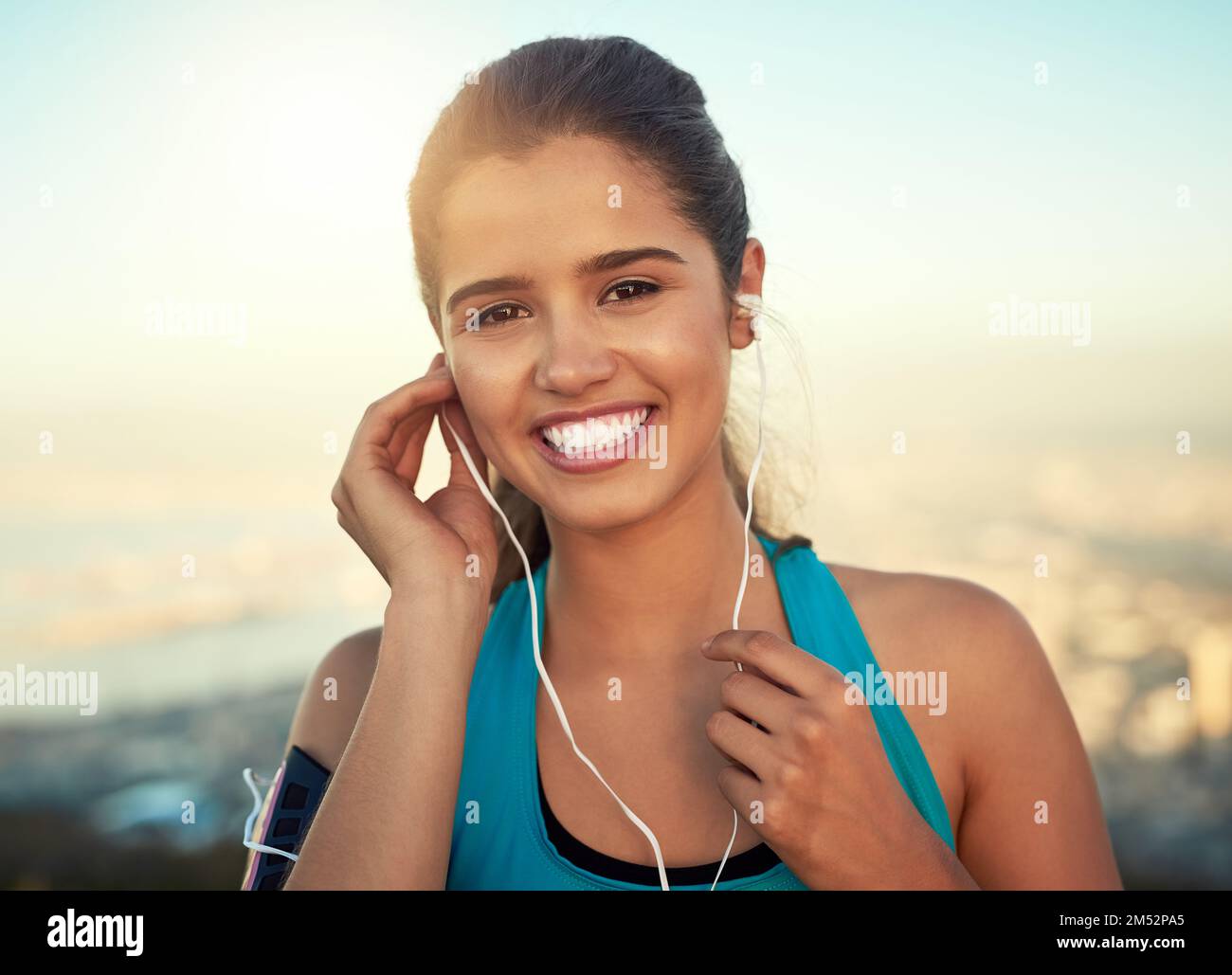 My playlist is never dull. a young woman listening to music while out ...