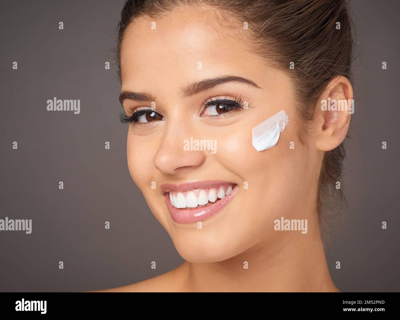 Ive got confidence in my cream. Portrait of a youthful model applying ...