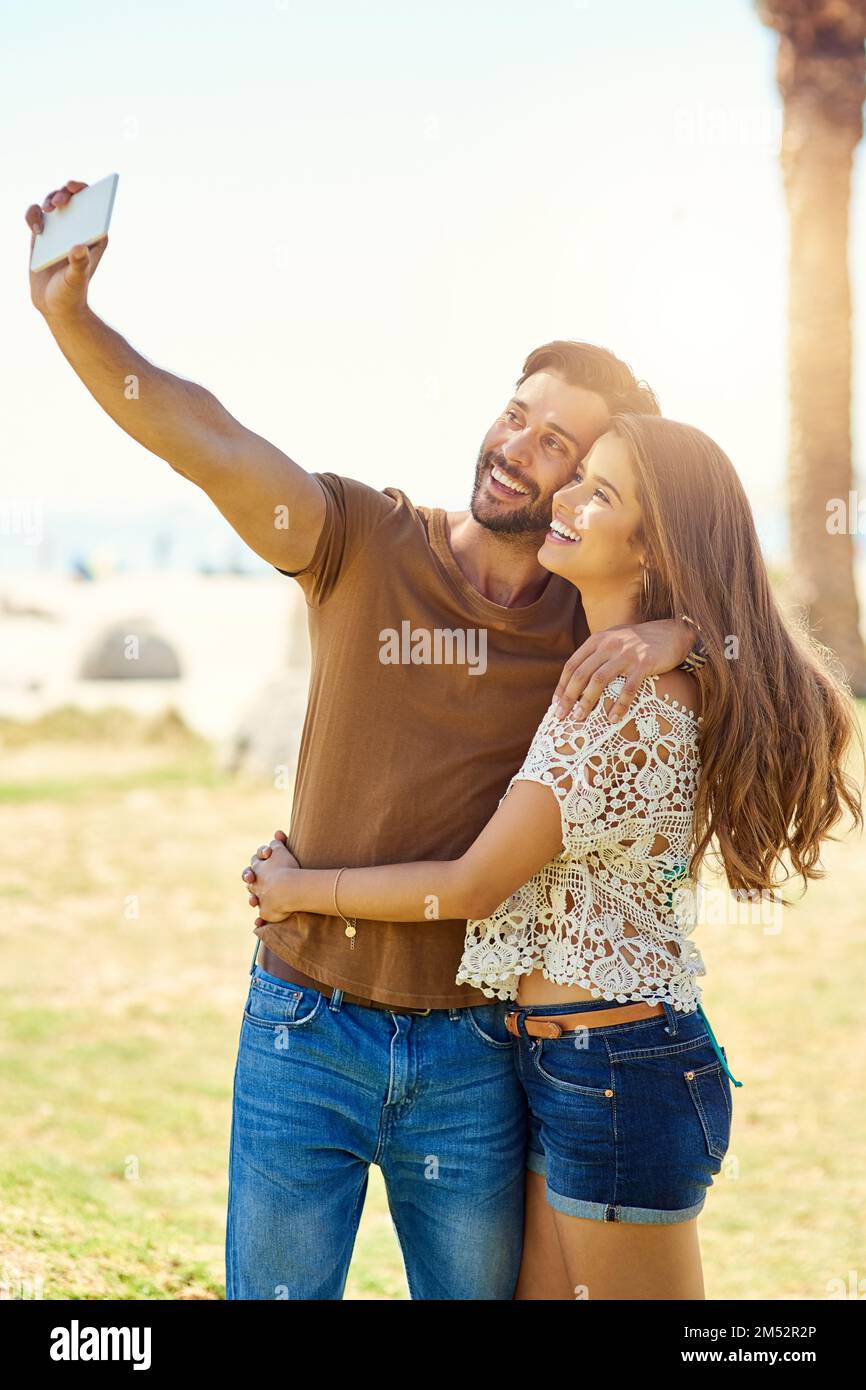Making Summer Memories A Smiling Young Couple Taking A Selfie Together