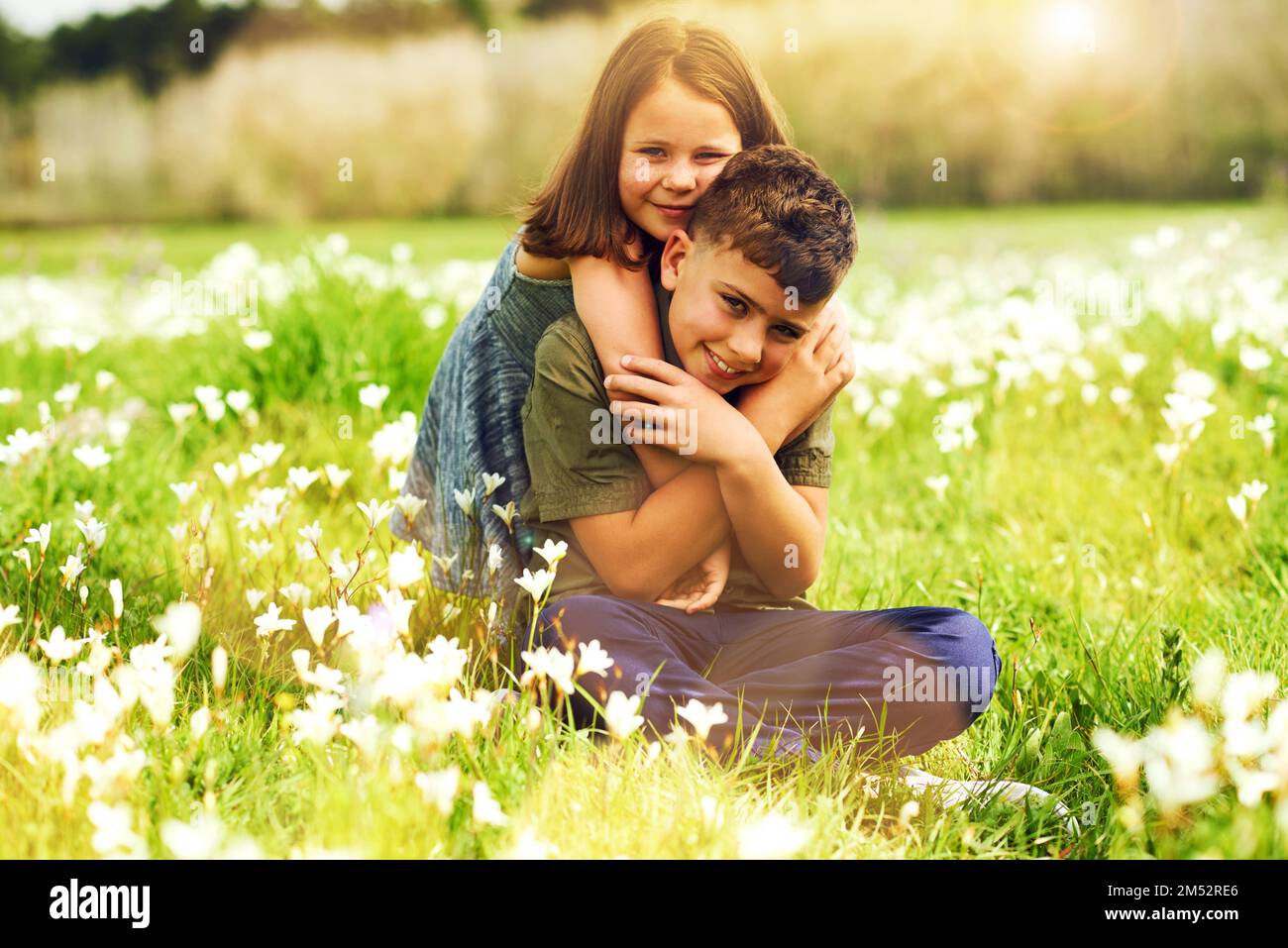Siblings share a special bond. Portrait of a cute little girl giving ...