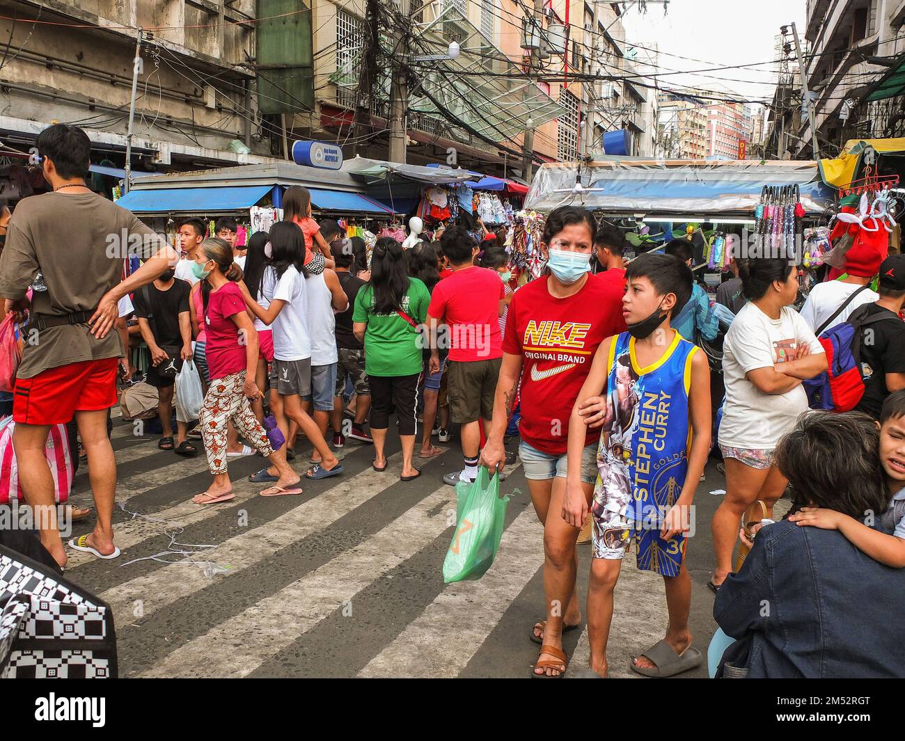 Manila, Philippines. 24th Dec, 2022. People passed through a narrow ...