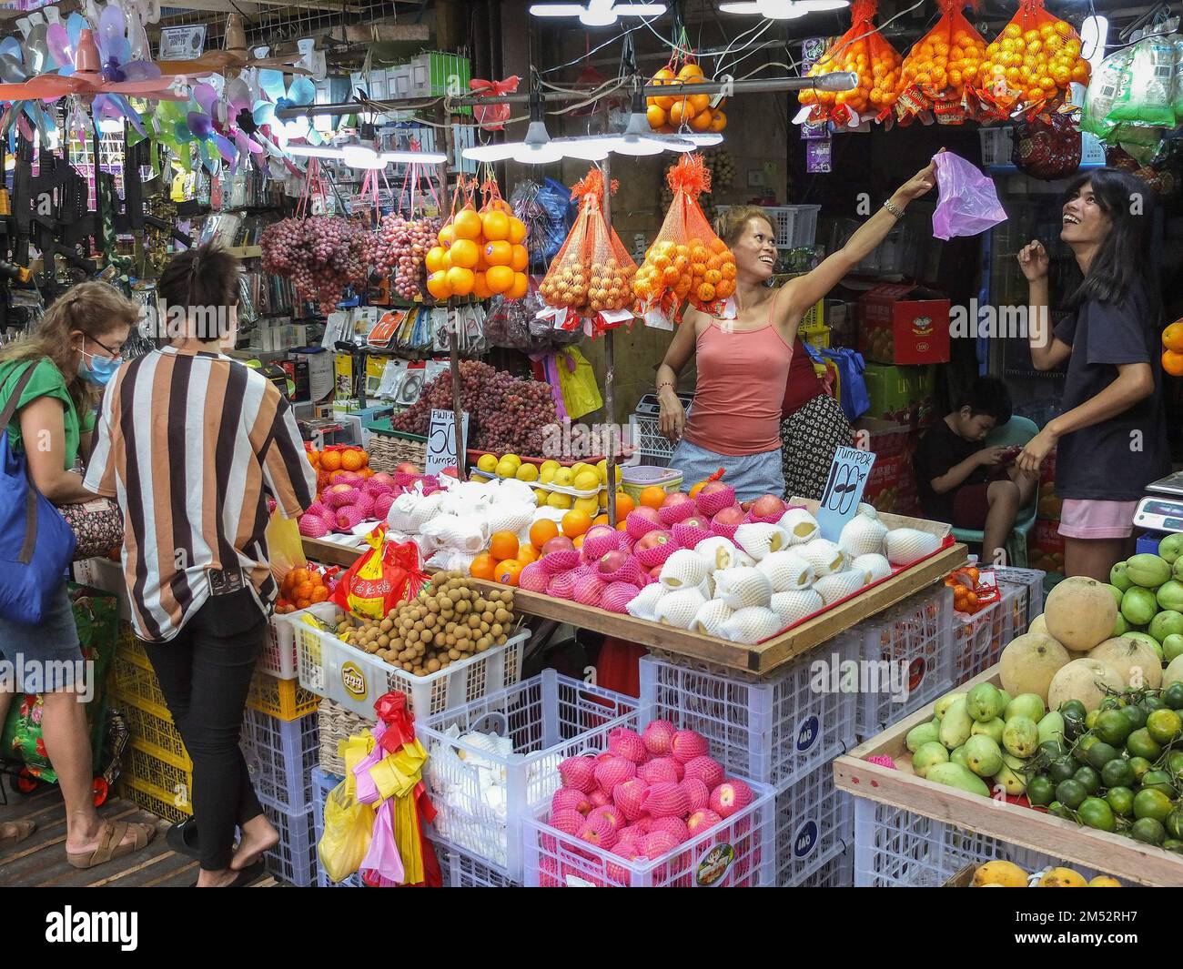 Manila, Philippines. 24th Dec, 2022. Fruit vendors are busy selling ...