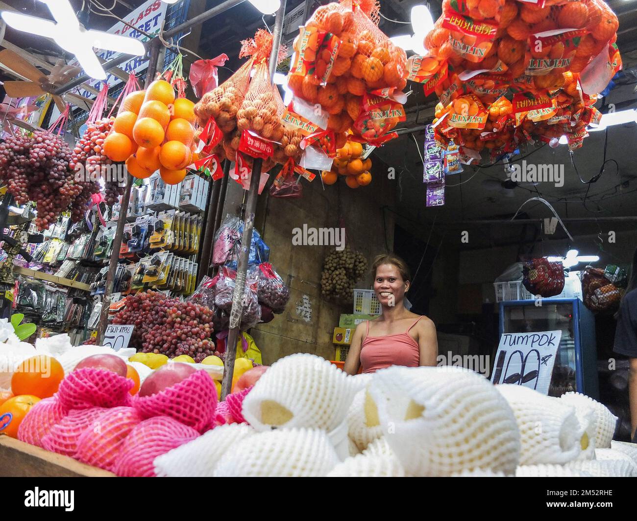 Manila, Philippines. 24th Dec, 2022. A fruit vendor smiles at the ...