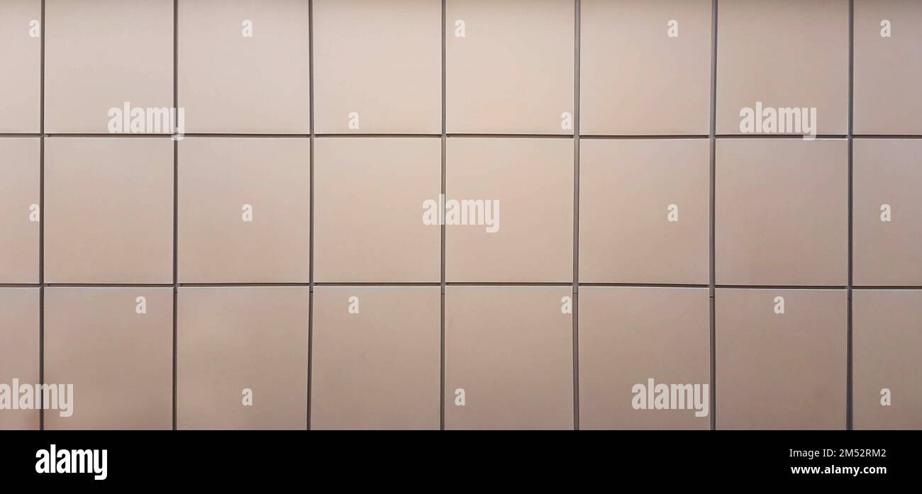 light facing tiles on the wall of a city building Stock Photo - Alamy