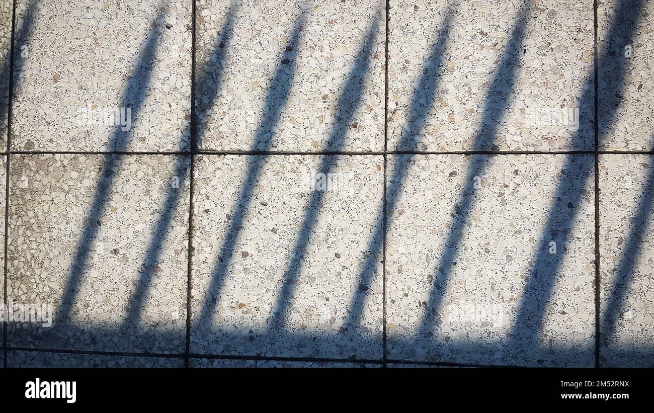 shadows from the railing on floor marble tile. background Stock Photo ...