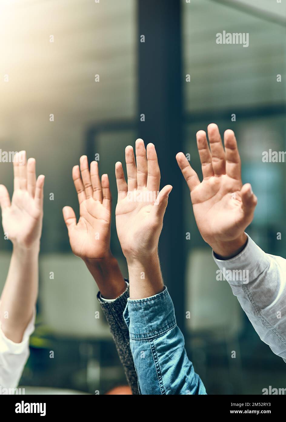 Pick us. a group of unrecognizable businesspeople raising their hands ...
