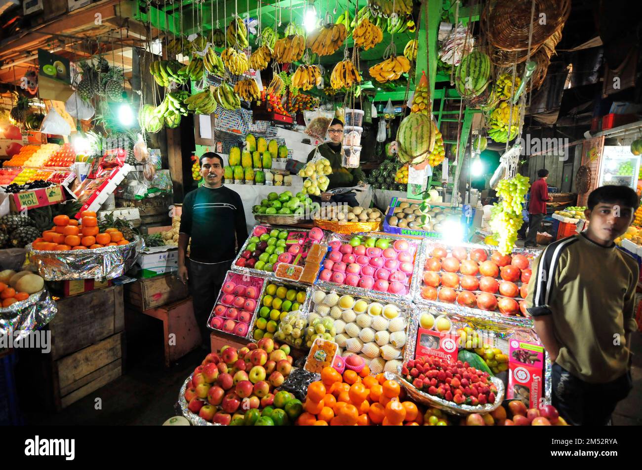 A colorful fruit shop at the New Market in Kolkata, West Bengal, India ...