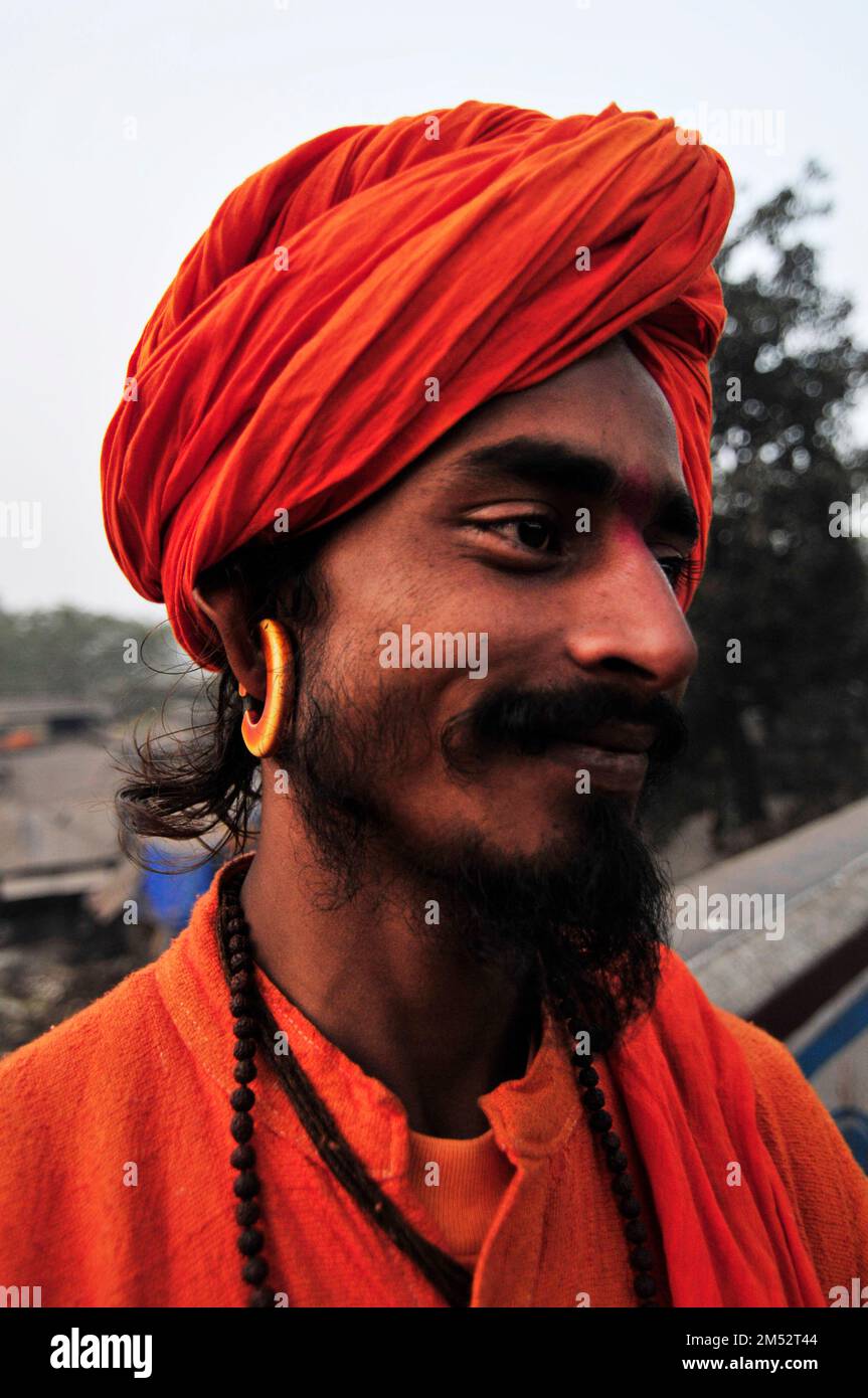 A Hindu sadhu wearing a large earing Stock Photo - Alamy