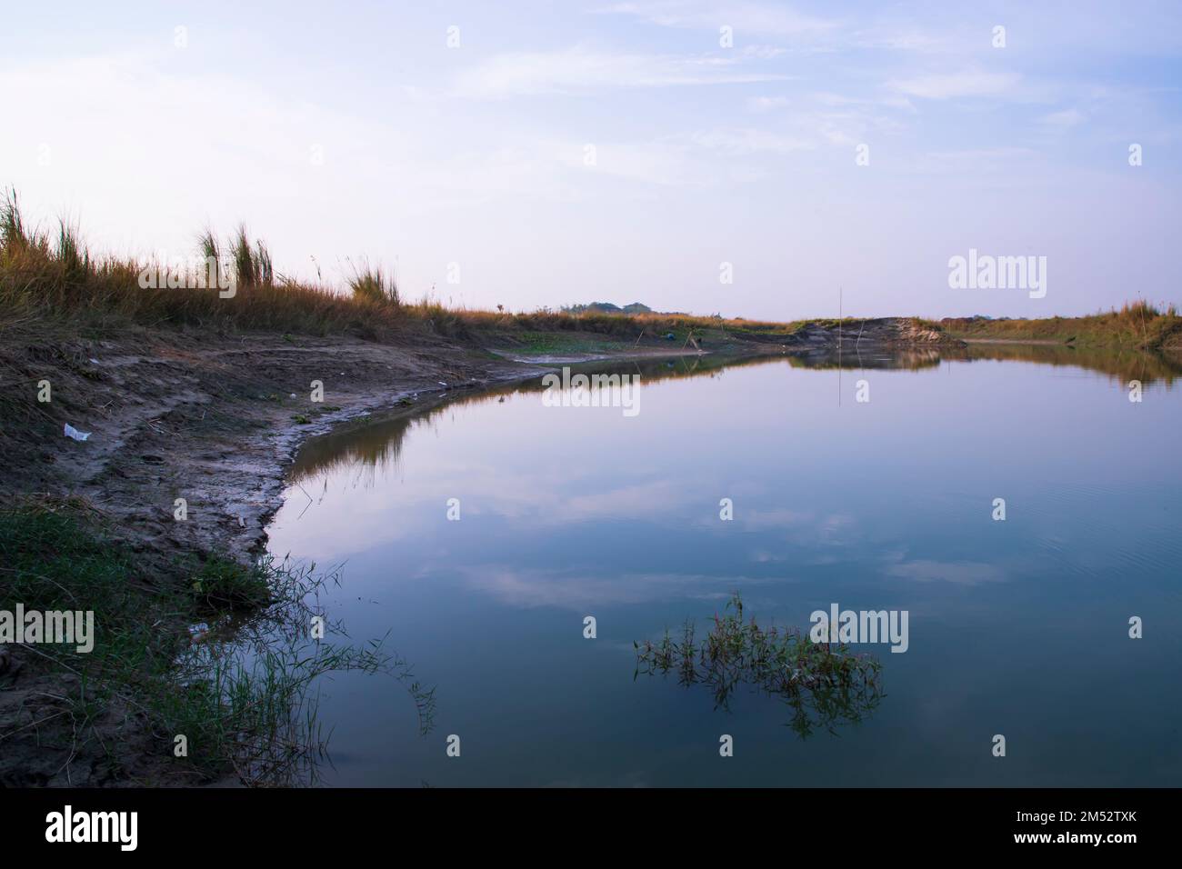 Arial View Canal with green grass and vegetation reflected in the water ...