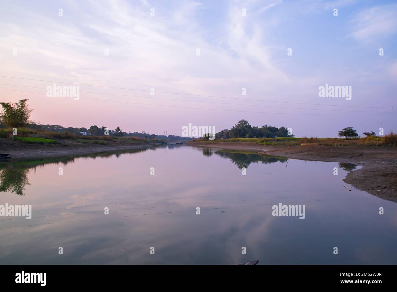 Arial View Canal with green grass and vegetation reflected in the water ...