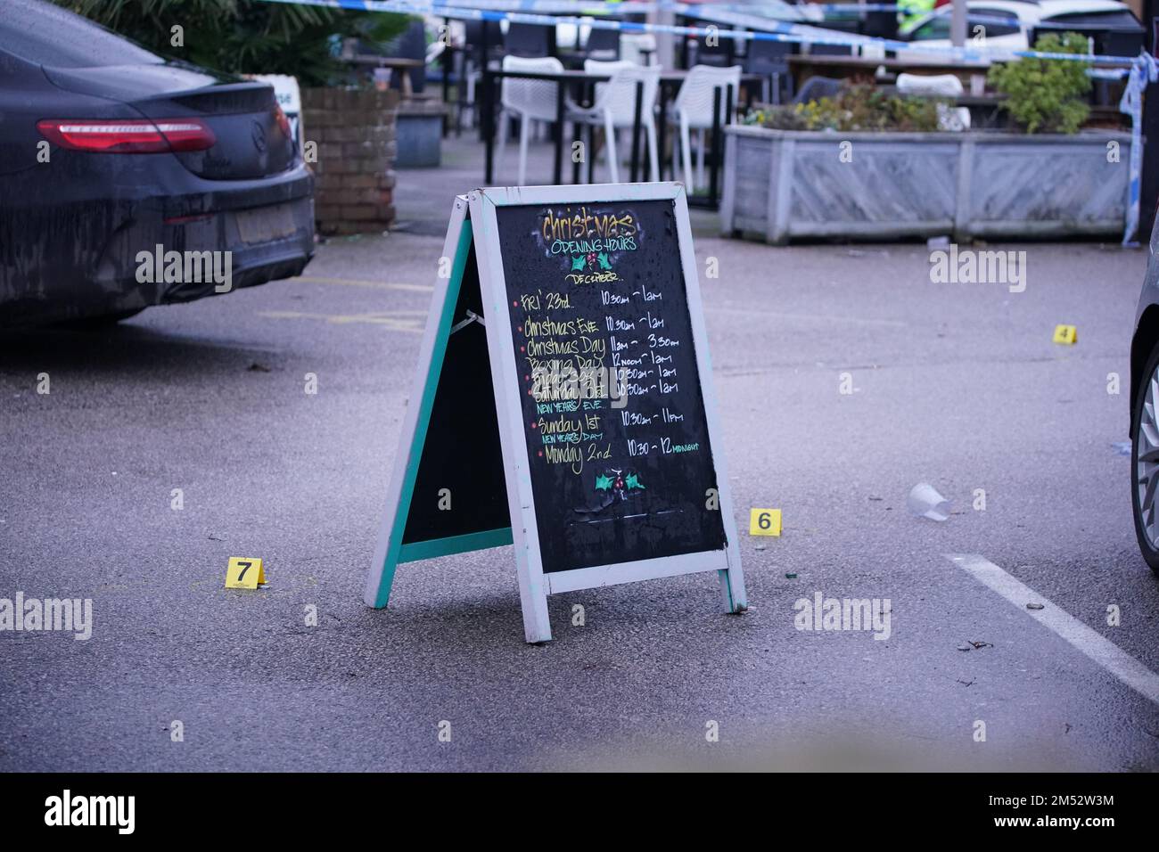 Evidence markers around a pub advertising board at the Lighthouse Inn ...