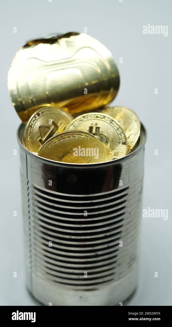 A closeup shot of coins in a tin can isolated on a white background ...