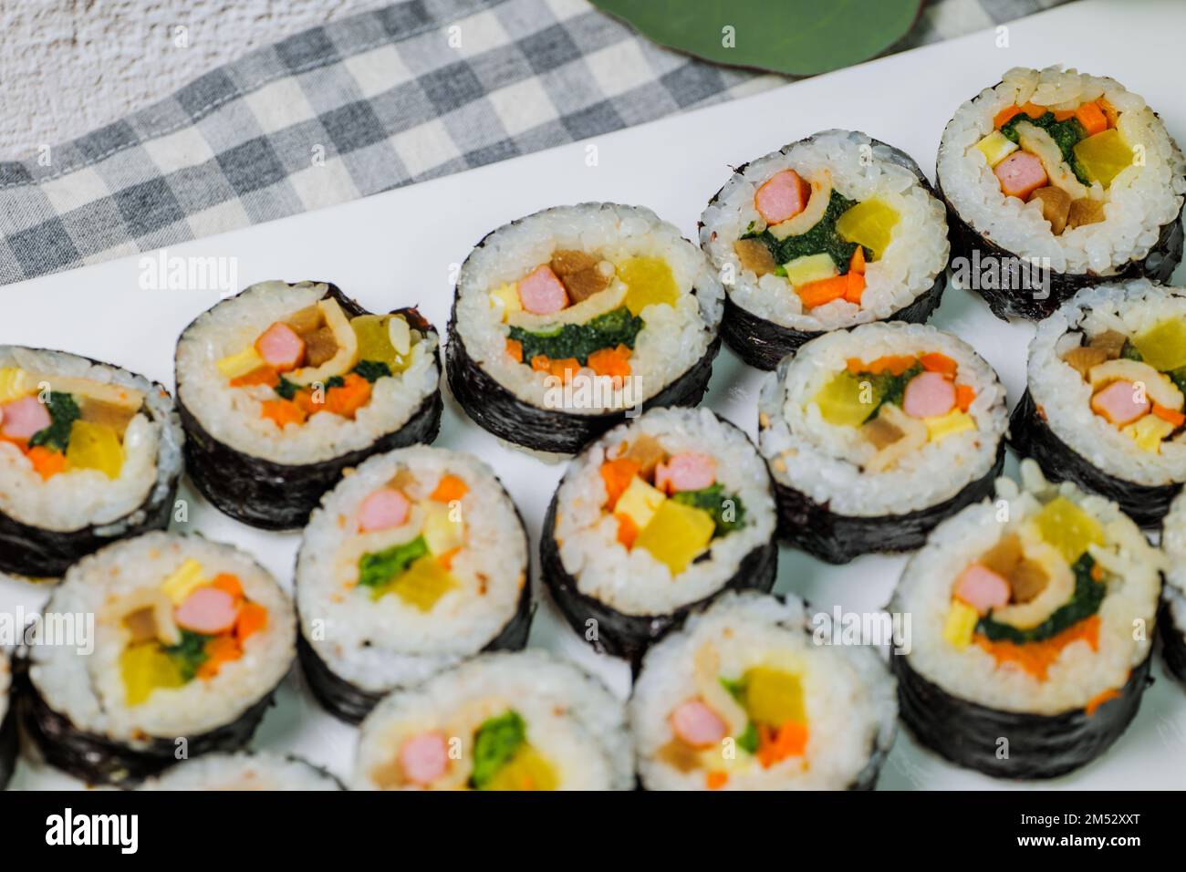 Rice seasoned with salt and sesame oil and rolled up in a sheet of ...