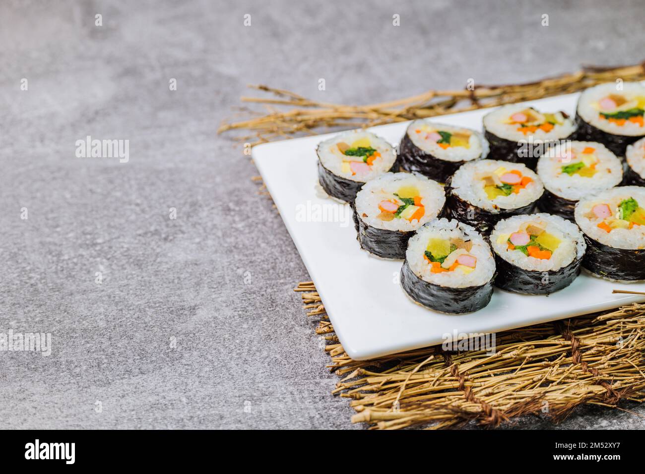 Rice seasoned with salt and sesame oil and rolled up in a sheet of ...