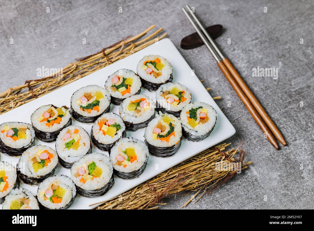 Rice seasoned with salt and sesame oil and rolled up in a sheet of ...