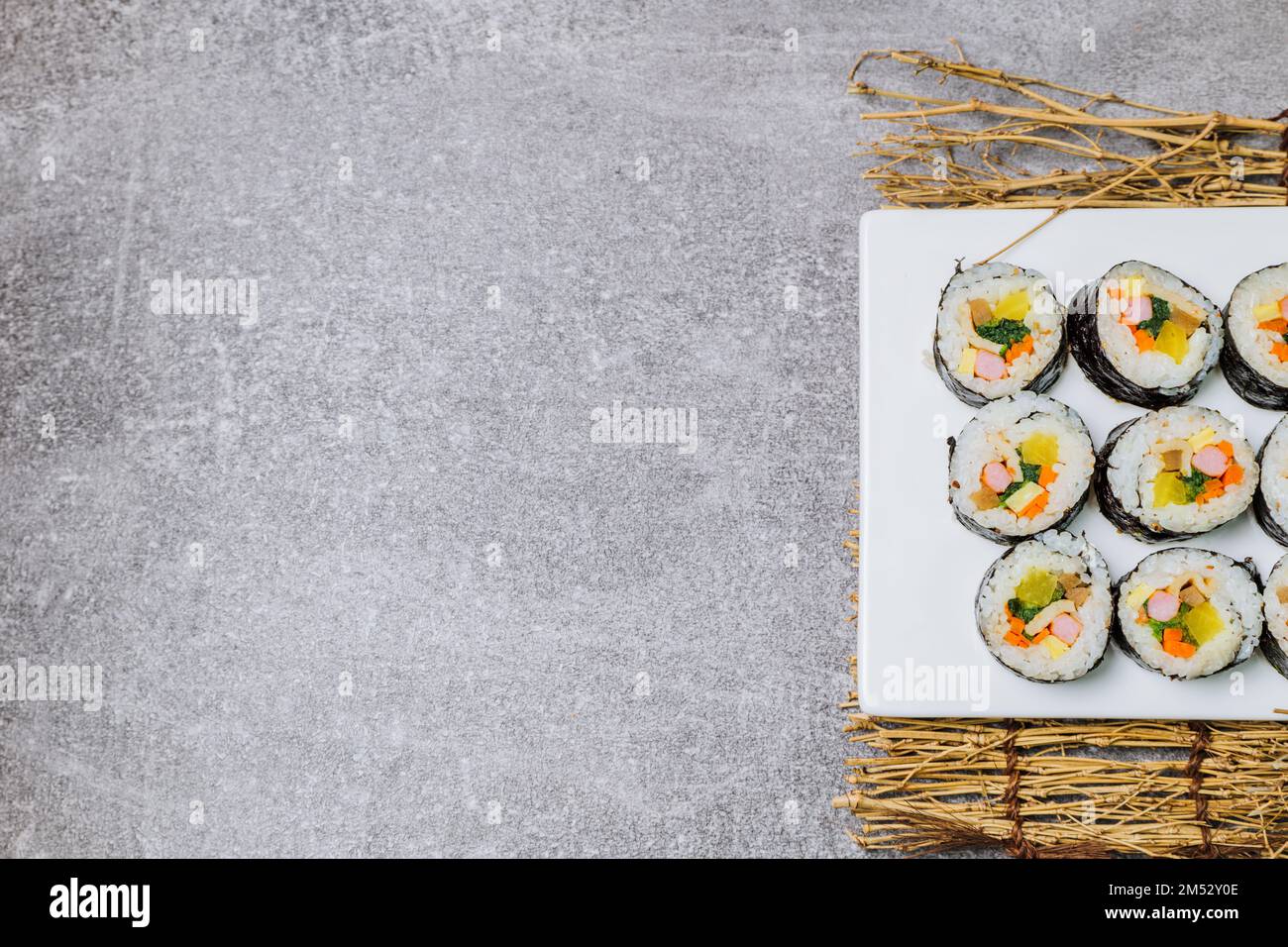 Rice seasoned with salt and sesame oil and rolled up in a sheet of ...