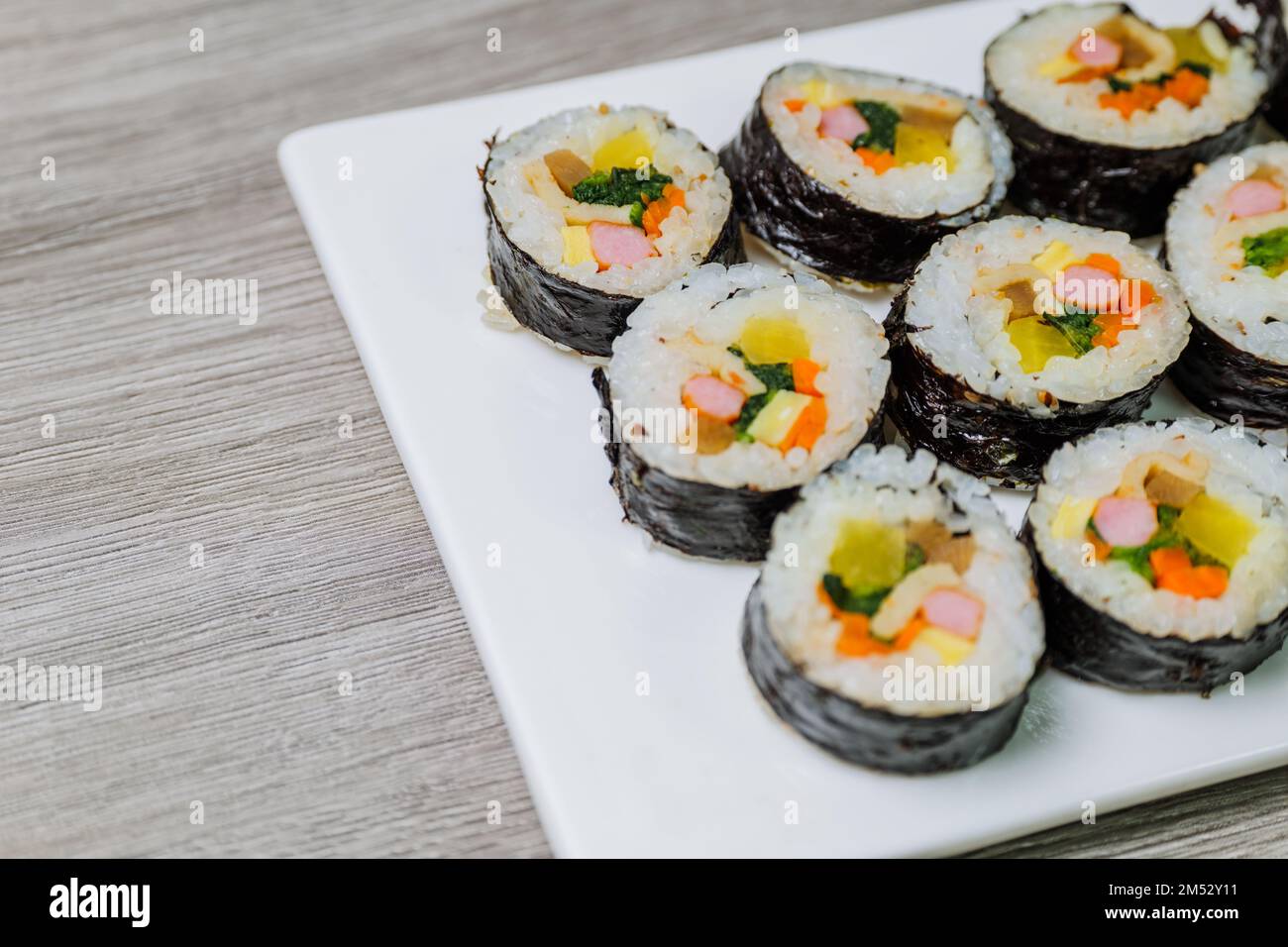 Rice seasoned with salt and sesame oil and rolled up in a sheet of ...