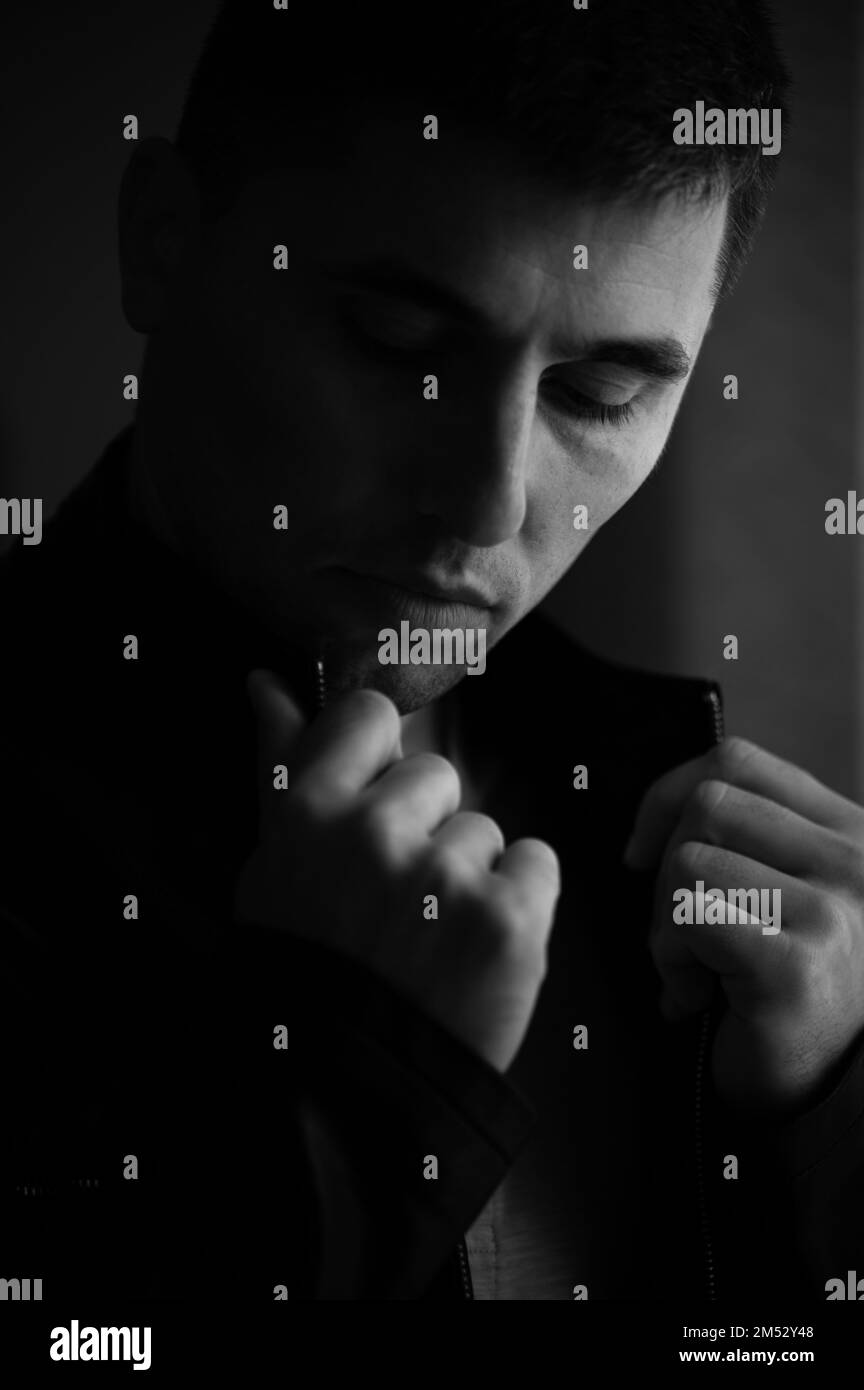 Monochrome portrait of a man with light from the window, portrait of a ...