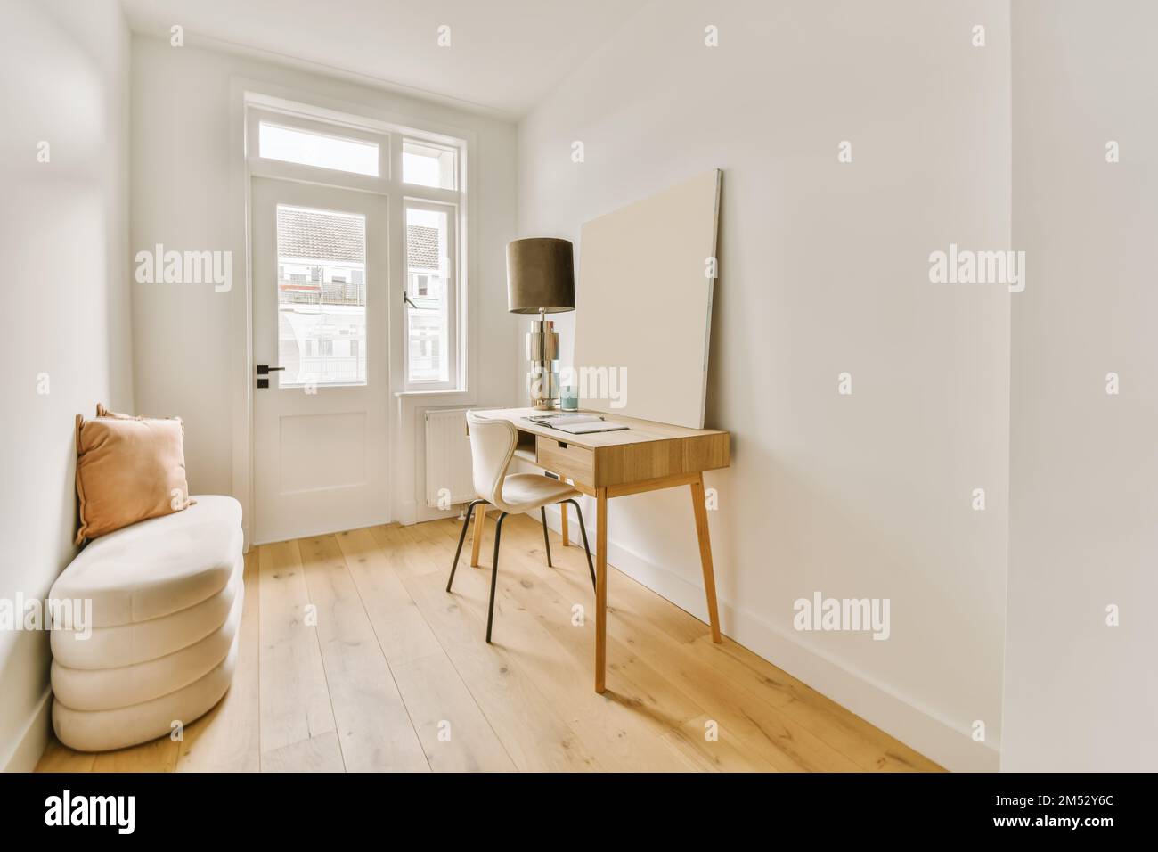 a living room with white walls and hardwood flooring the room is well ...
