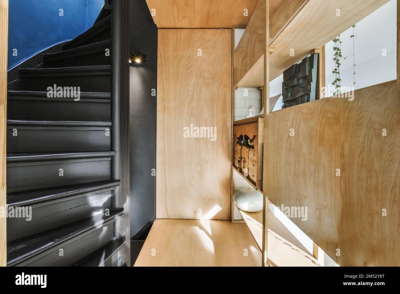 the inside of a house with wooden walls and stairs leading up to the ...