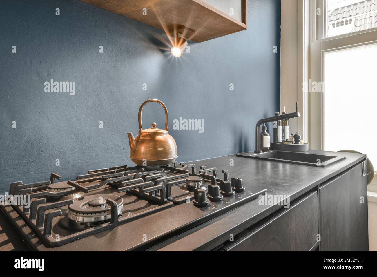 a kitchen with a kettle on it's burner and the stove is in front of an ...