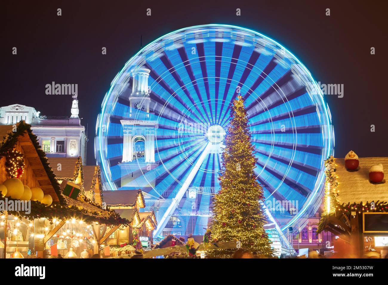 Christmas market with New Year Tree in Kyiv, Ukraine. The Ferris wheel ...