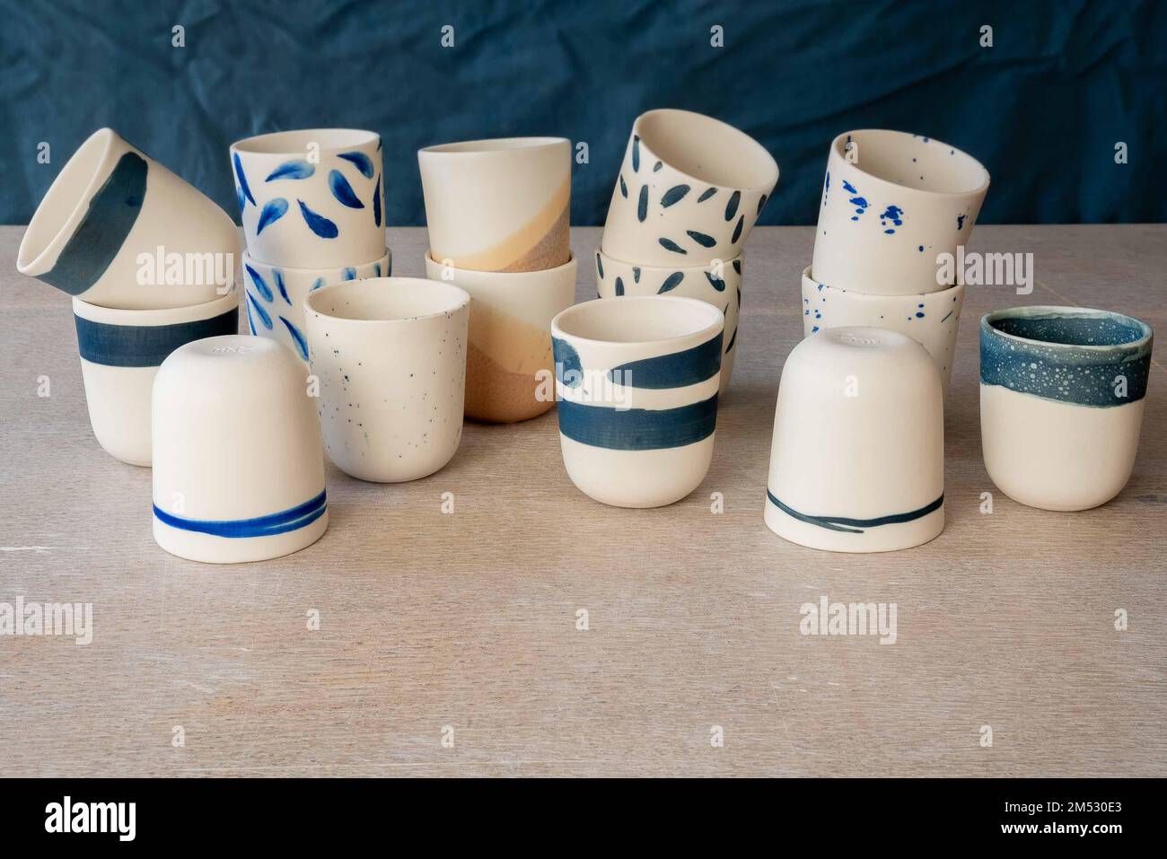 Luxury decorated white ceramic dipped mugs with blue lines on marble ...