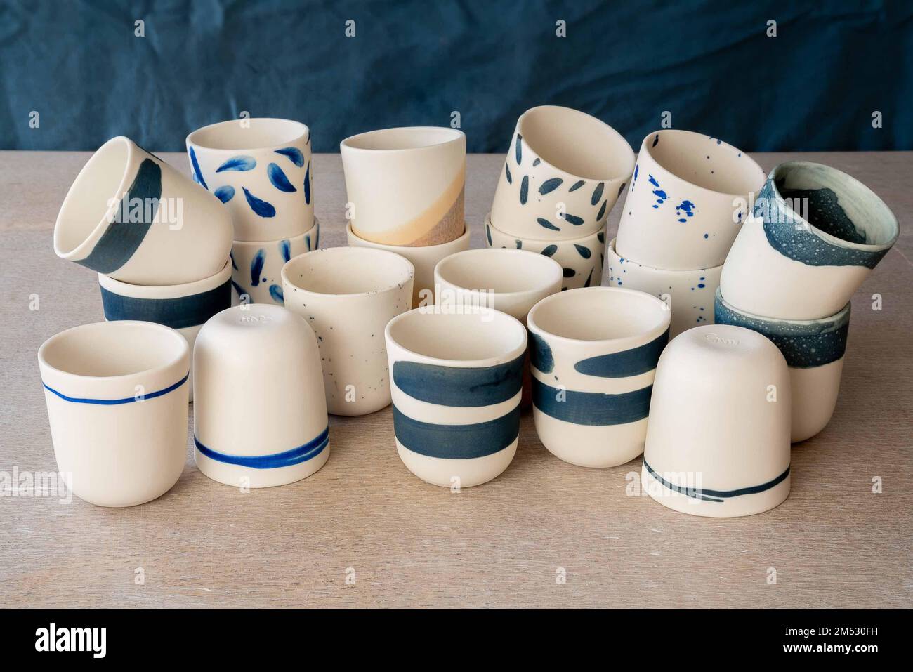 Luxury decorated white ceramic dipped mugs with blue lines on marble ...