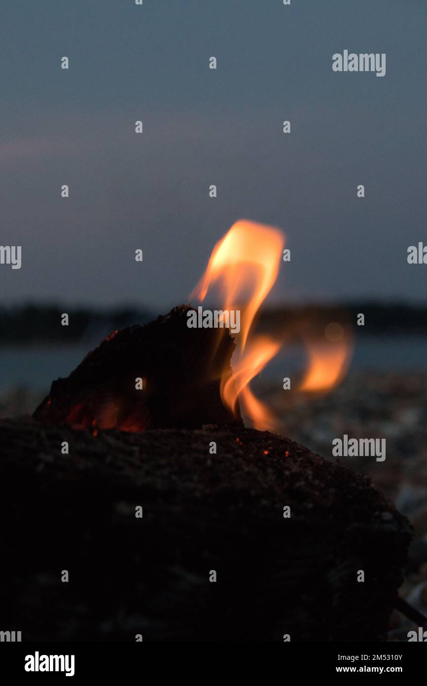 A vertical closeup shot of a campfire at the beach Stock Photo - Alamy
