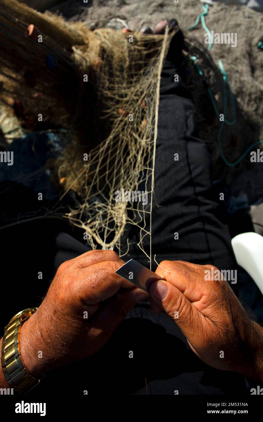 fishing net in the hands of fisherman, with needle and thread, grabs ...