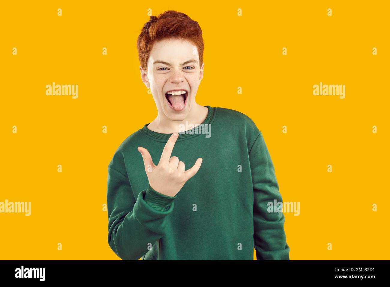 Studio portrait of funny, cheerful, excited child model doing heavy ...