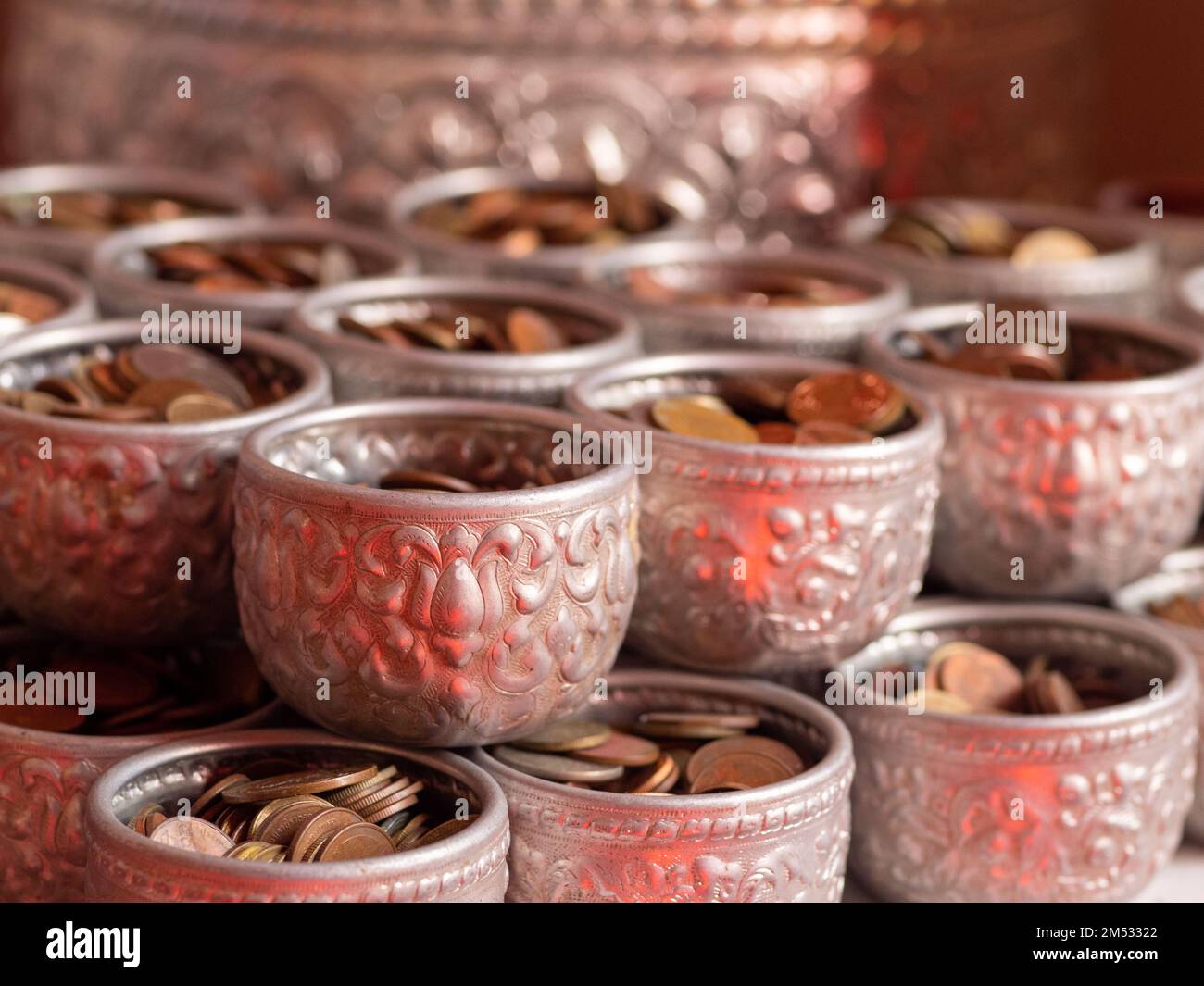 Silver bowl that holds coins according to Buddhist beliefs at ...
