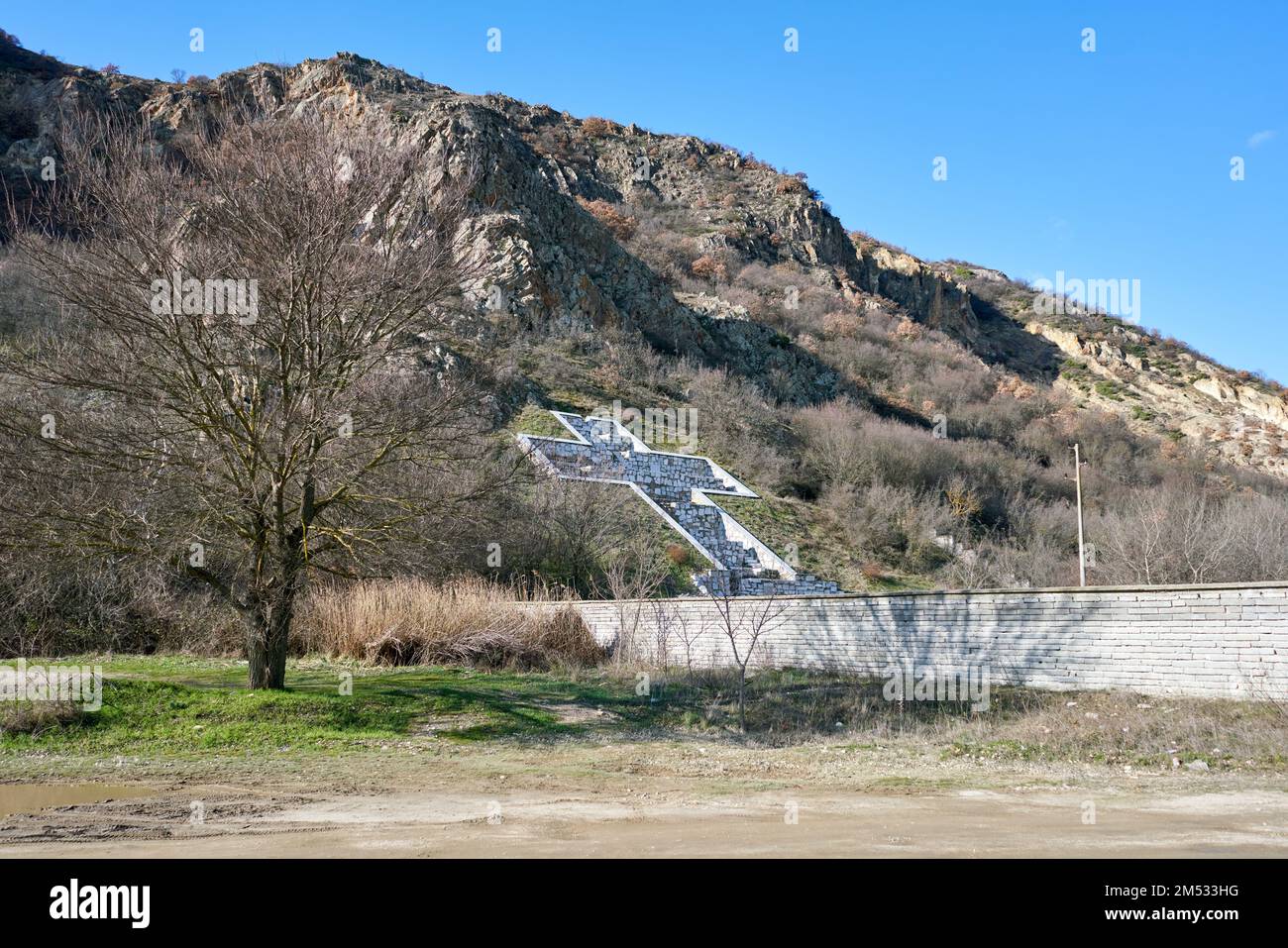 A brick cross on the slope of a rocky hill on a sunny morning Stock ...